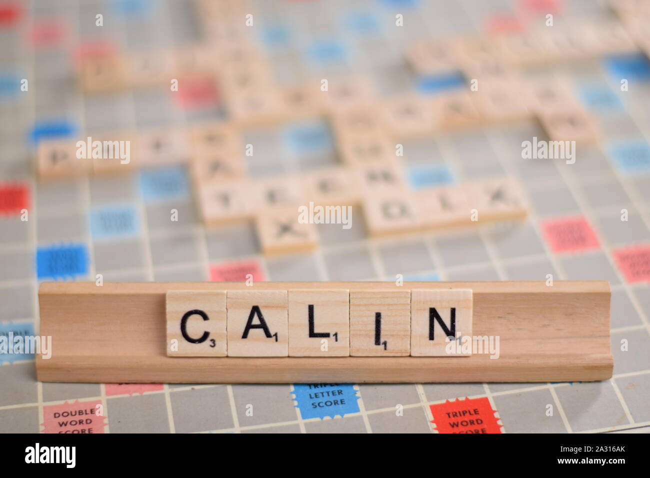The French word 'calin' (in English: 'hug') in wooden scrabble tiles on ...