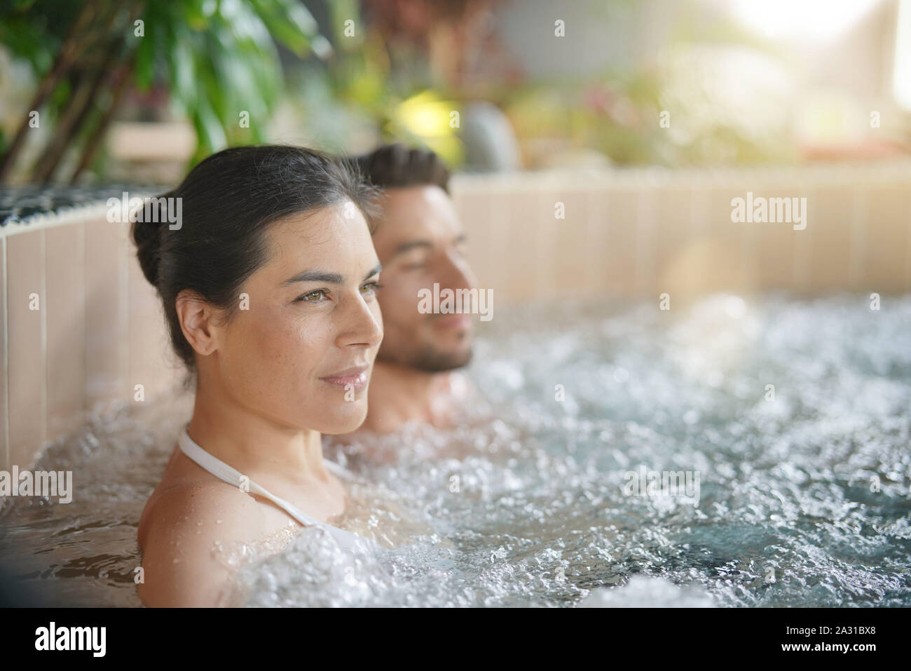 Couple relaxing in spa resort hot pool Stock Photo - Alamy