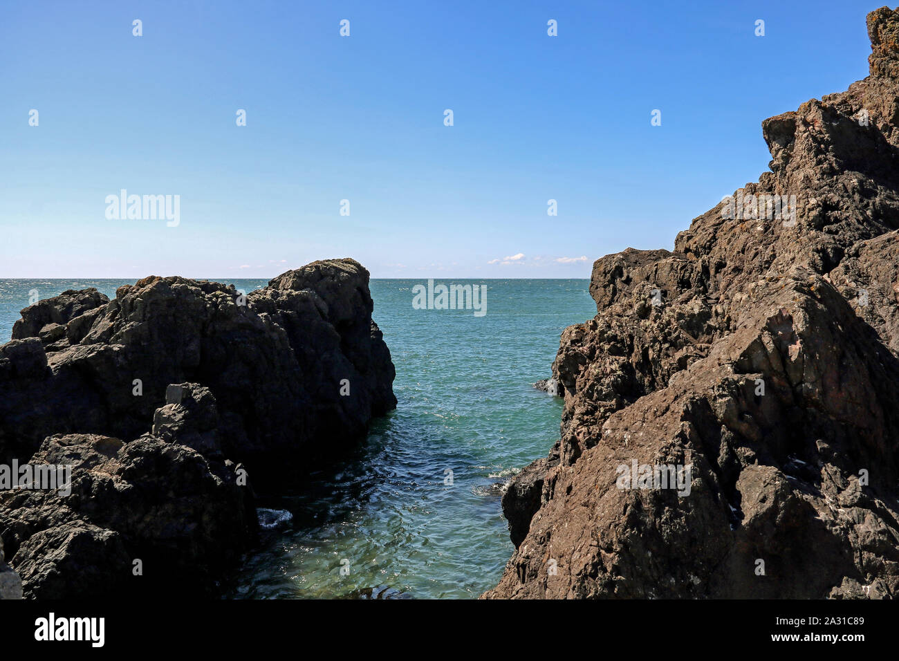 Sea inlet and rock formations at a coastal location Stock Photo - Alamy