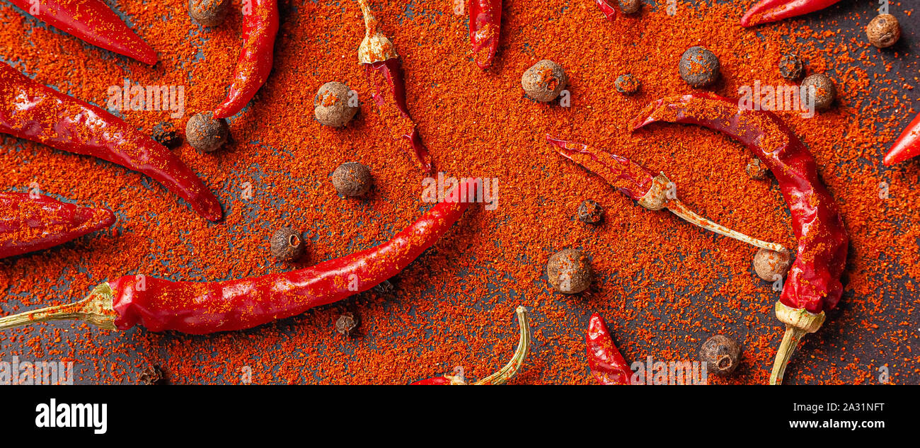 A lot of red and green pepper and pepper. Sprinkle paprika on a black ...