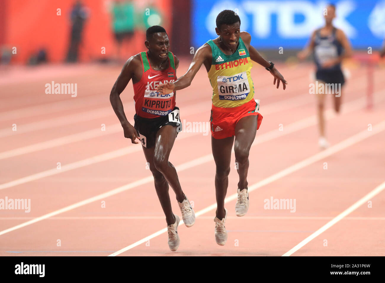 Kenya's Conseslus Kipruto (left) and Ethiopia's Lamecha Girma cross the ...