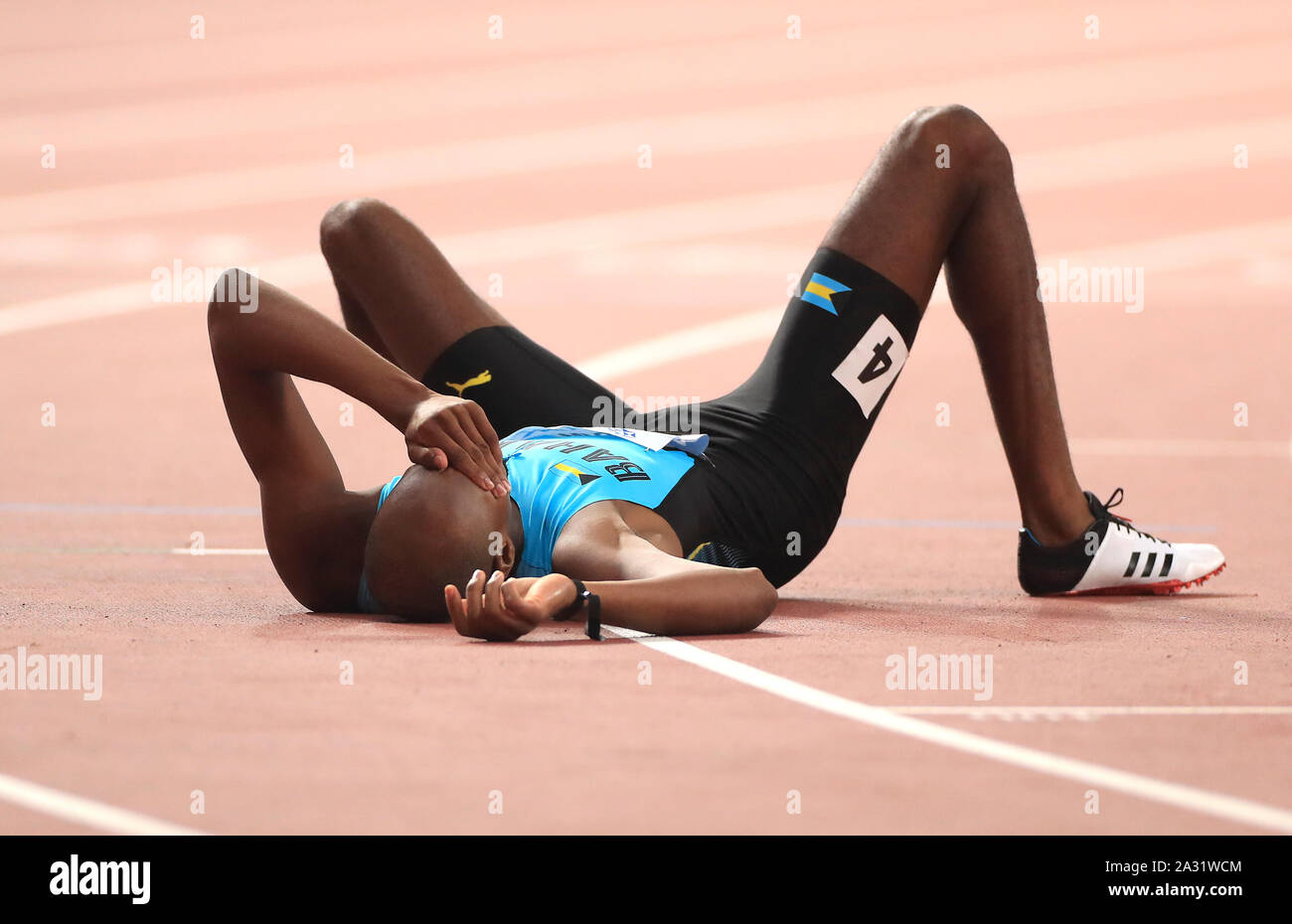Bahamas' Steven Gardiner crosses the finish line to win gold in the 400 ...