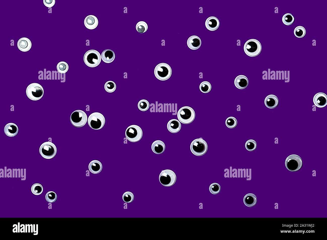 Funny Halloween concept for horror with eyes on dark purple color ...