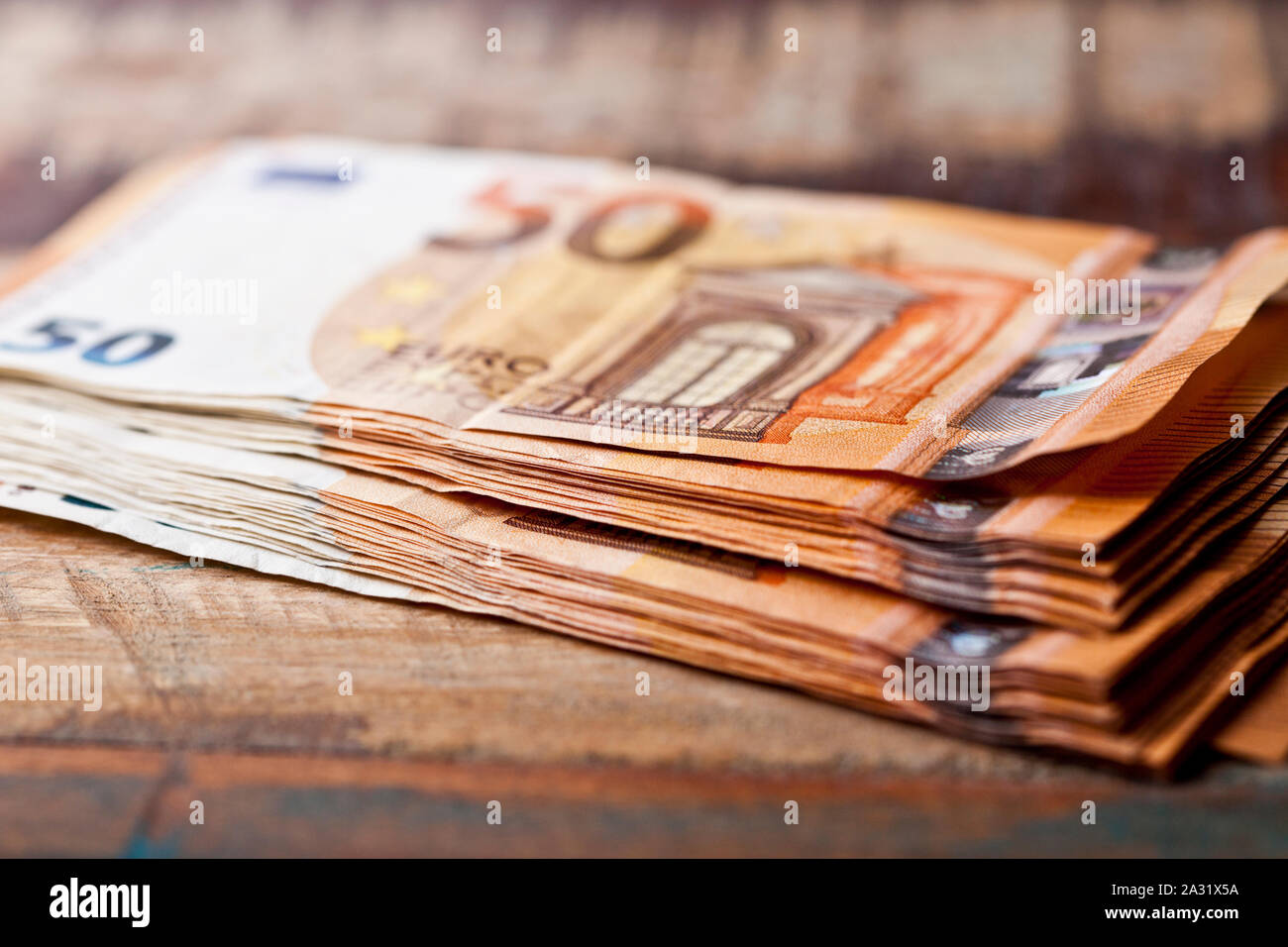 Pile of fifty euro banknotes. 50 euro currency notes stacked on rustic ...