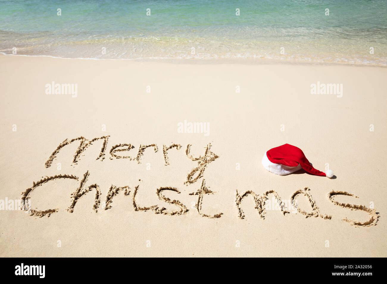 Merry christmas written on sand hi-res stock photography and images - Alamy