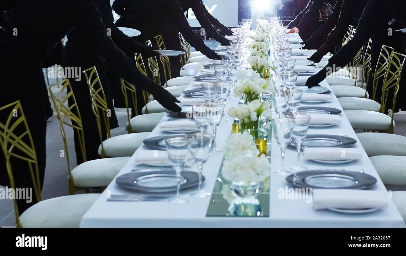 Large group of waiters serving a banquet Stock Photo - Alamy