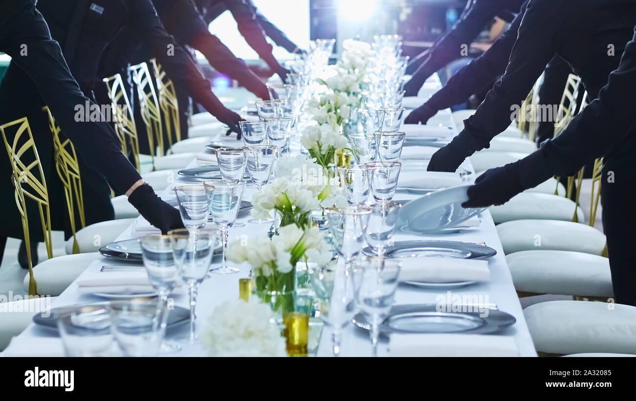 Large group of waiters serving a banquet Stock Photo - Alamy
