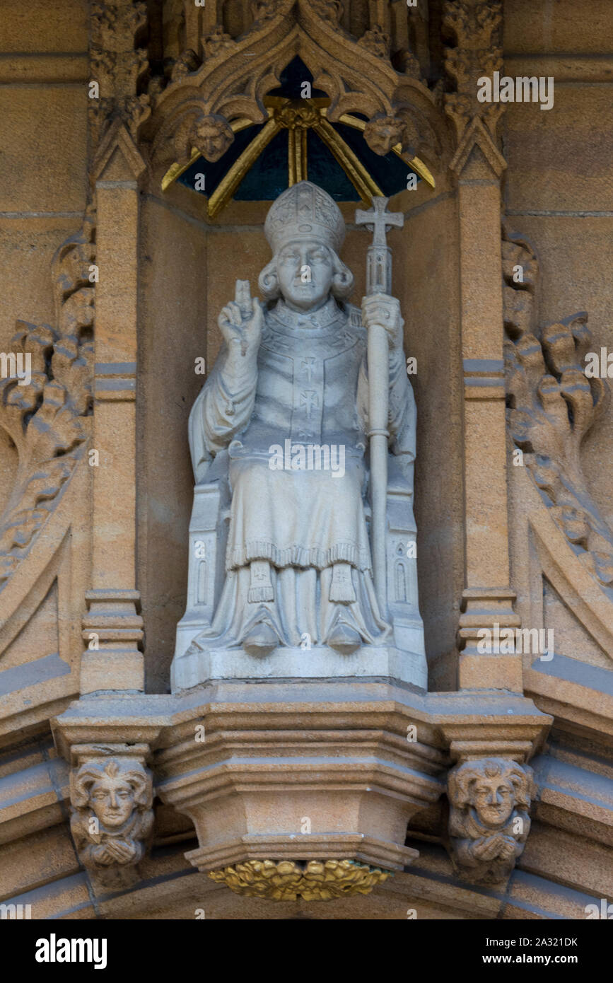 a religious bishop or priest statue with mitre and cross built into the ...