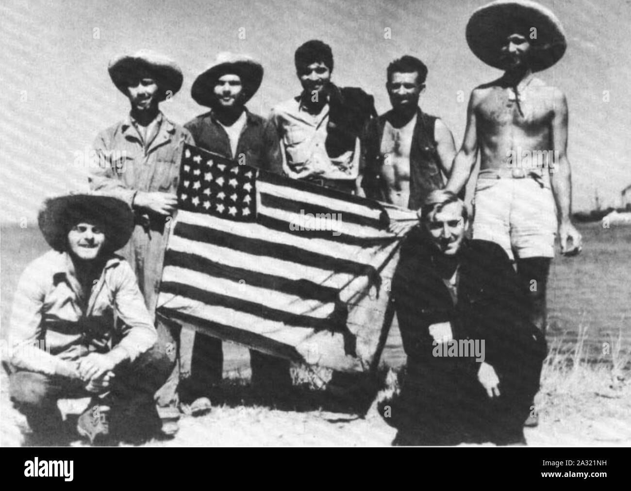 Escaped crew members of USS Quail (AM-15) with handmade US flag in ...
