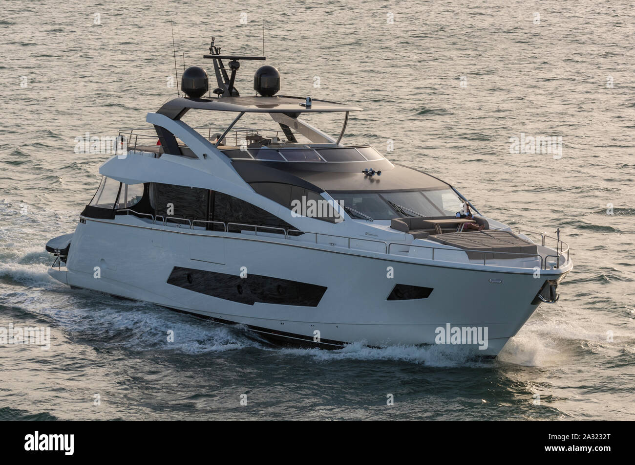 A large luxury motorboat or powerboat with tinted windows afloat and ...