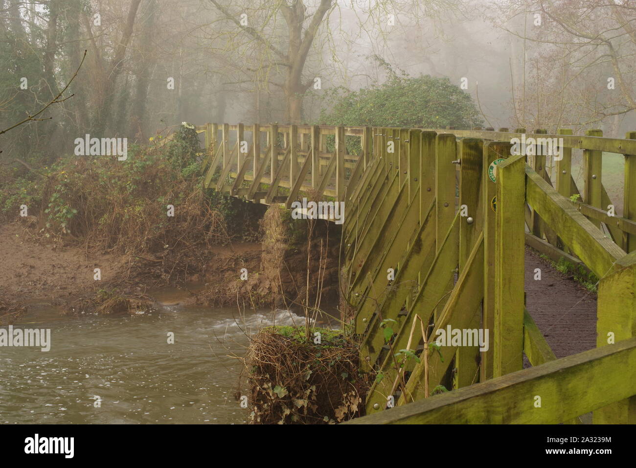 Wooden Footbridge over an Old Mill Leat on the River Exe on a Misty ...