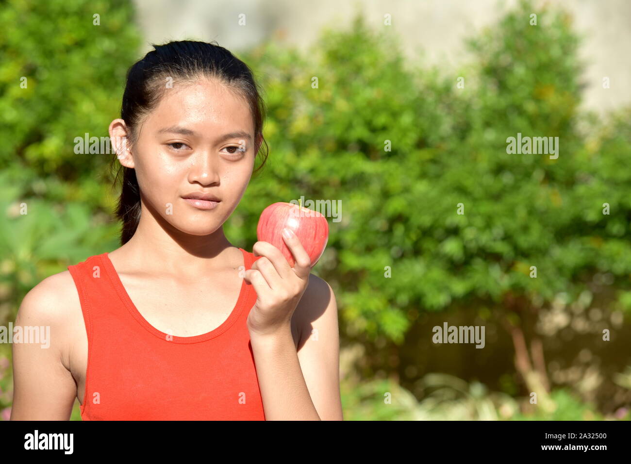 A Serious Female Youngster With Fruit Stock Photo - Alamy