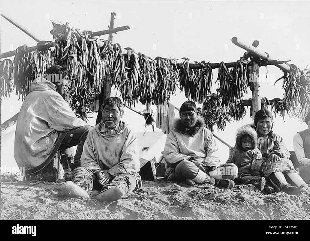 Eskimos sitting under a fish drying rack Alaska between 1901 and 1911 ...