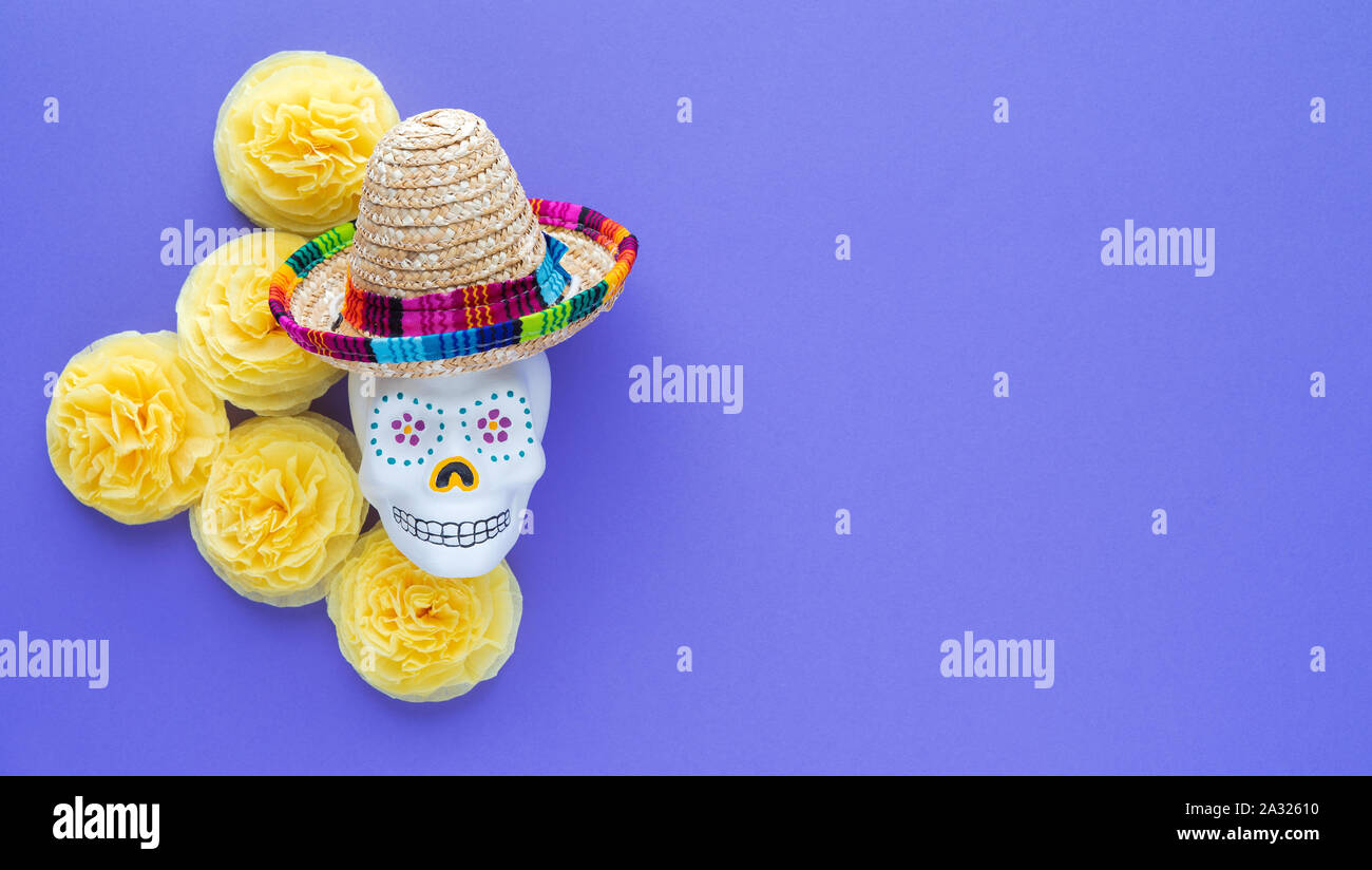 Mexican skull with hat with yellow flowers of paper cempasuchil on ...