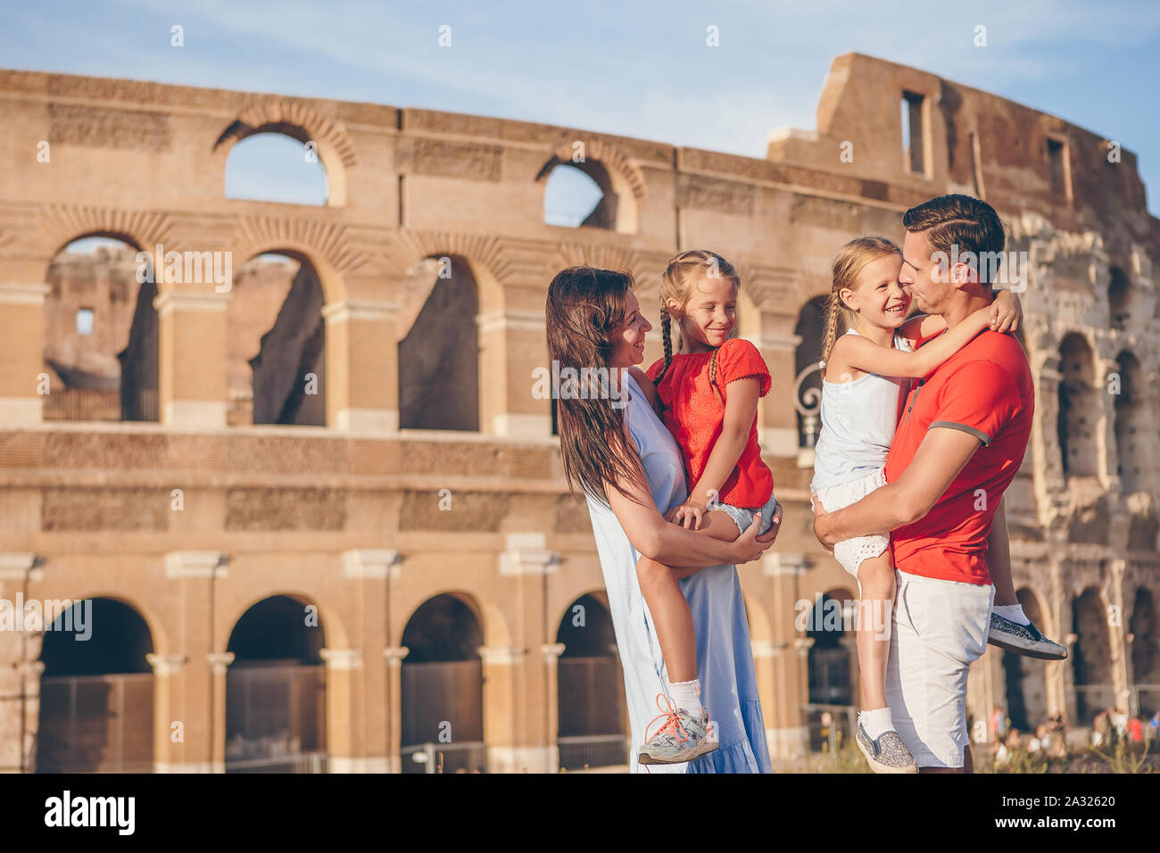 Happy parents with kids on roman vacations in Rome over Coliseum ...