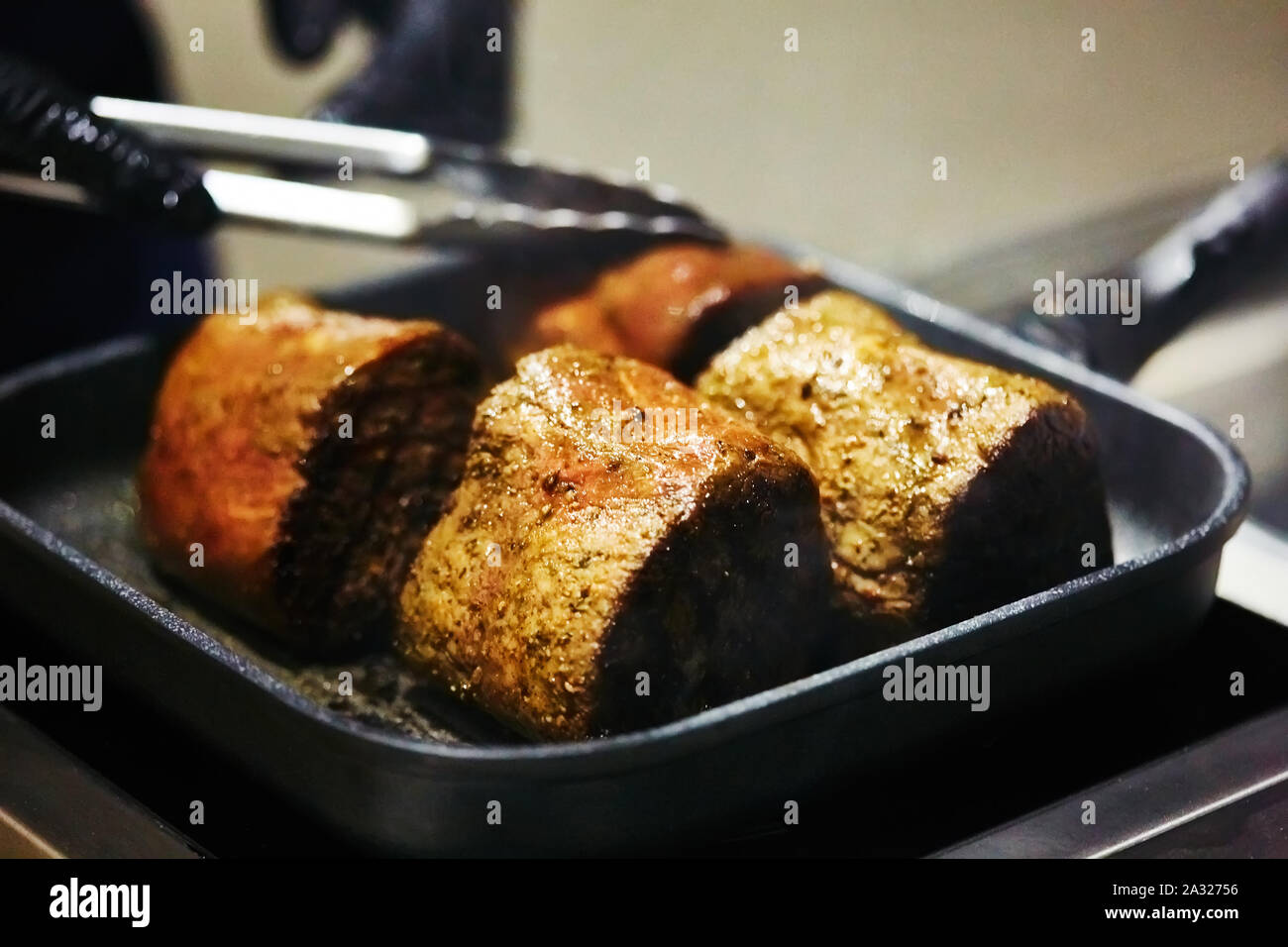 The beef steak in a frying pan. Shallow dof Stock Photo - Alamy