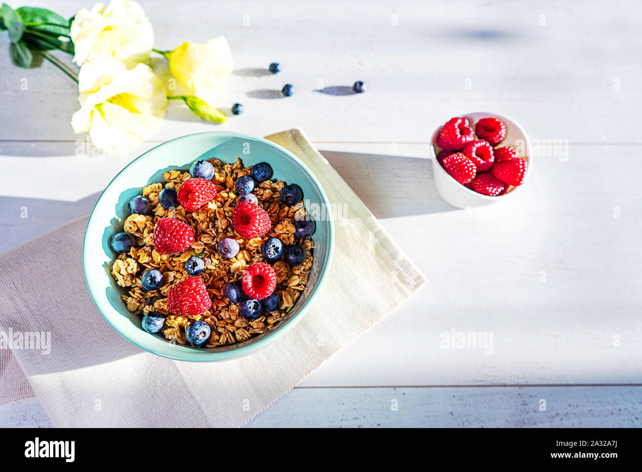 Bowl of homemade granola with fresh berries on gray wooden background ...