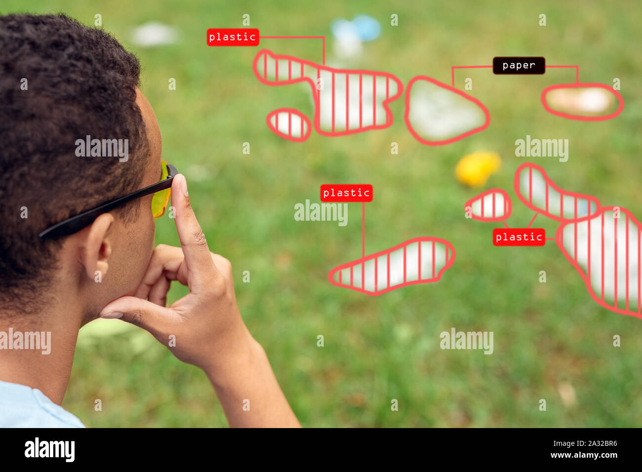 Smart Waste Sorting. African boy wearing digital glasses sitting in the ...