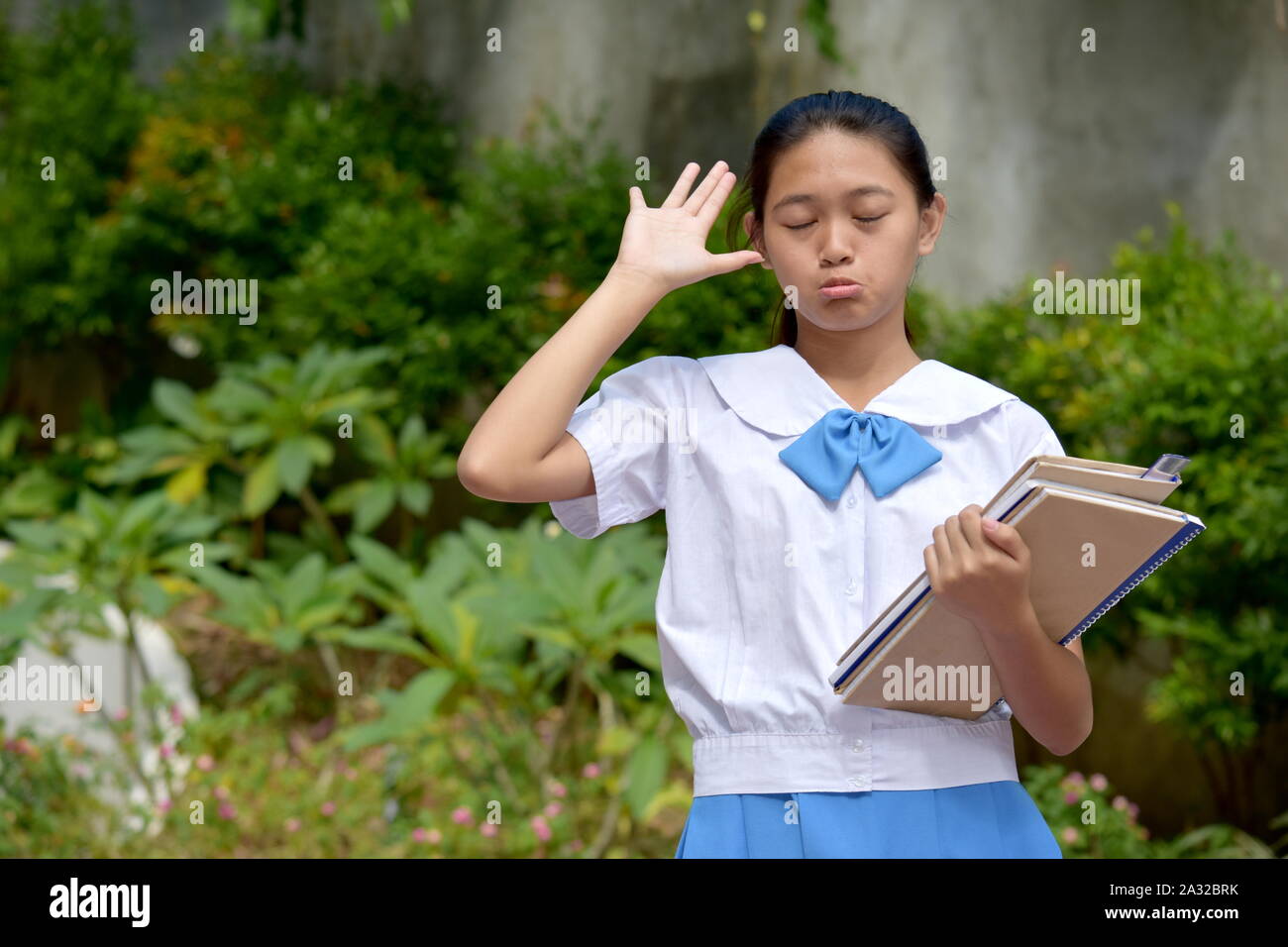 Female Student Making Funny Faces With School Books Stock Photo - Alamy