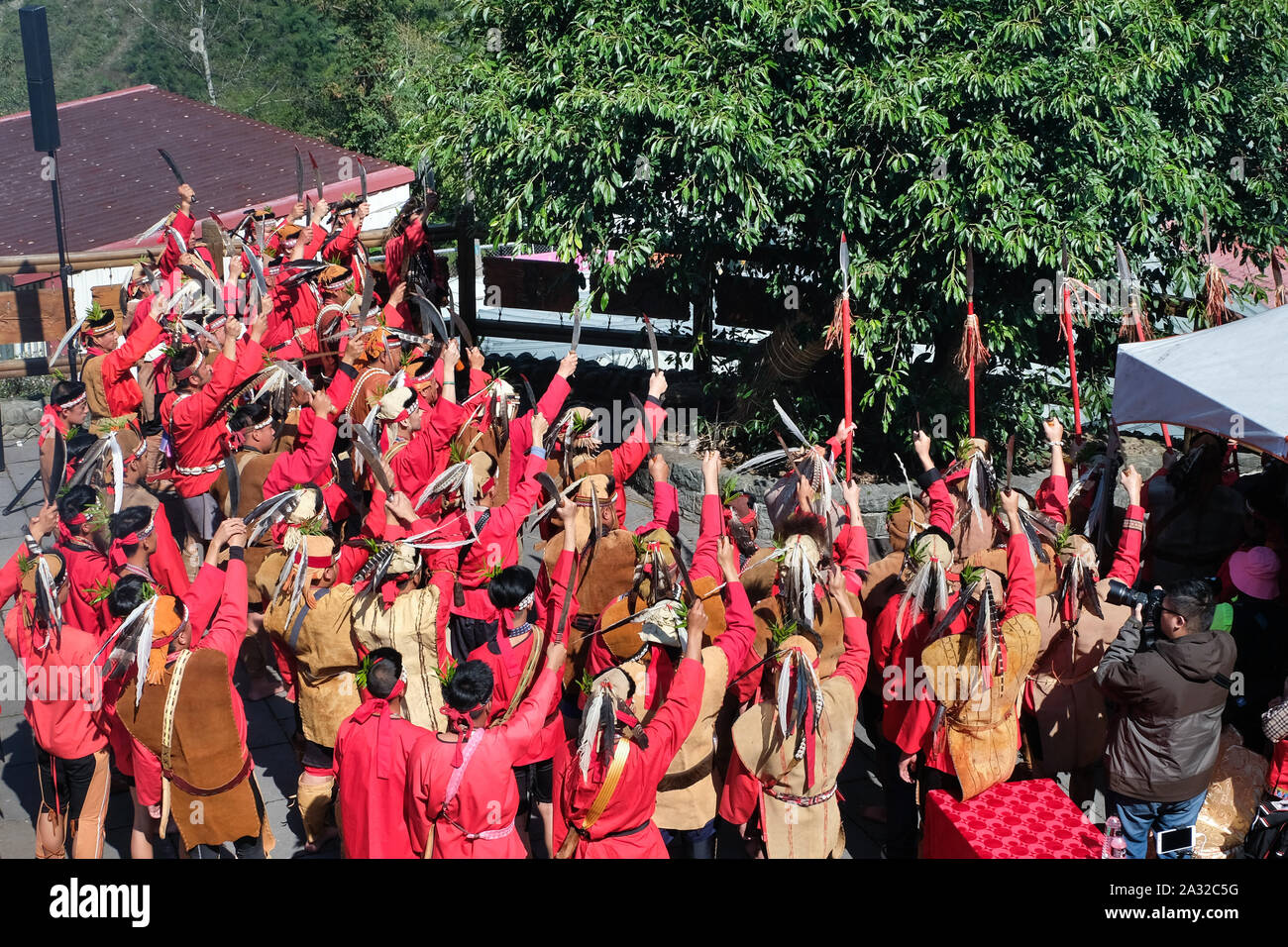 Tsou men cutting the branches from sacred Yono trees to create a ...