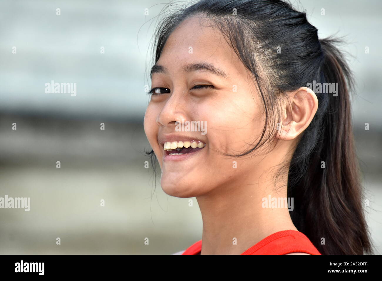 A Young Diverse Girl Winking Stock Photo - Alamy