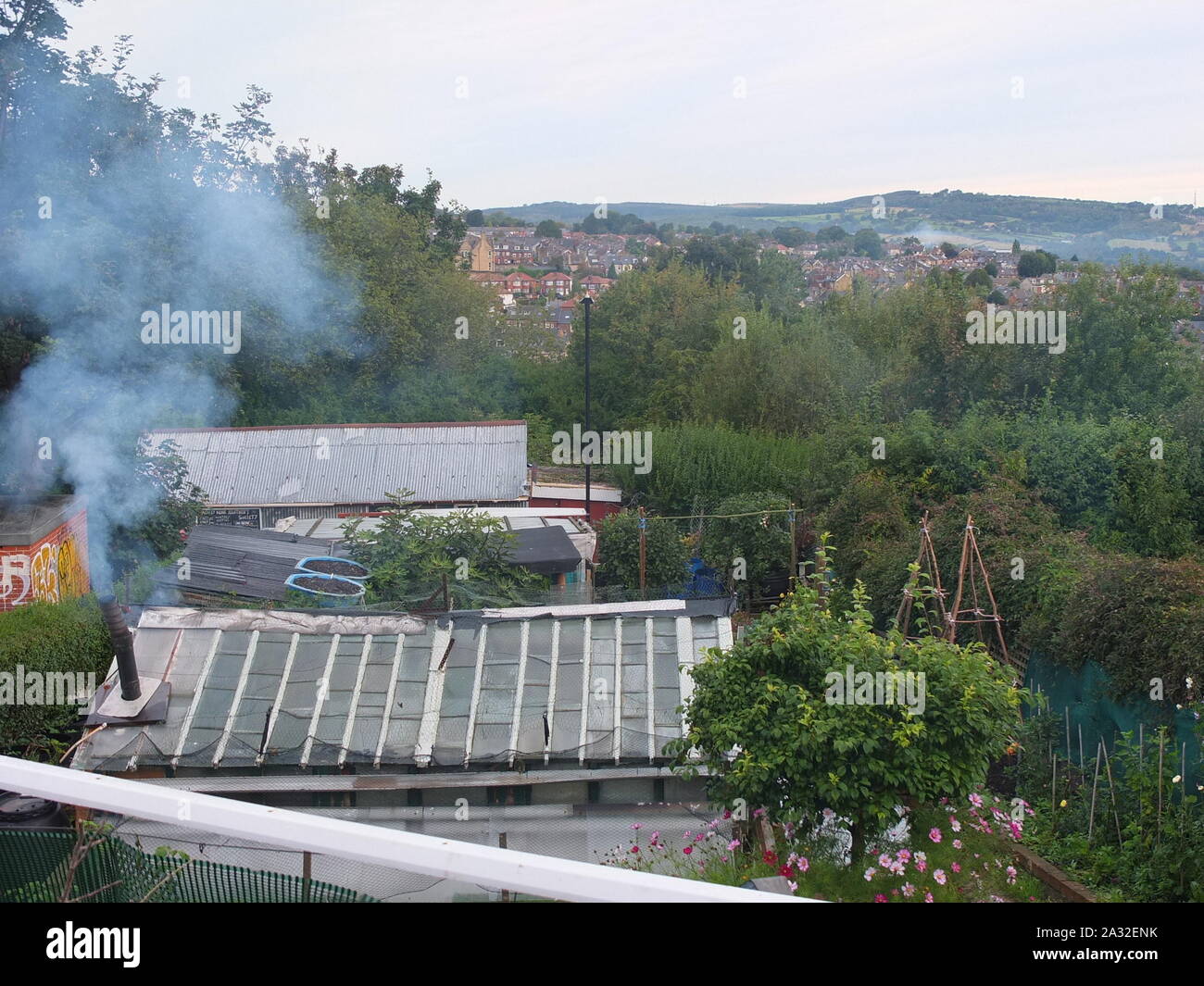 Urban UK allotments with city background on Autumn morning with shed ...
