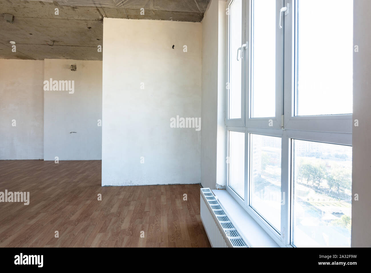 Large stained glass window and battery in the interior of an empty room ...