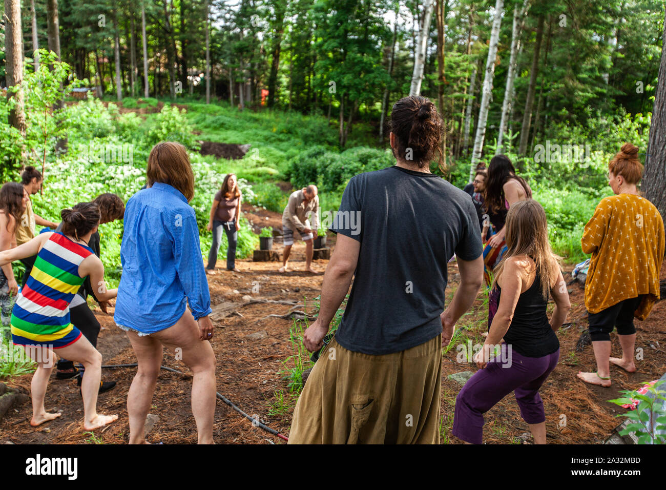 An intergenerational and colorful group of people are seen standing in ...