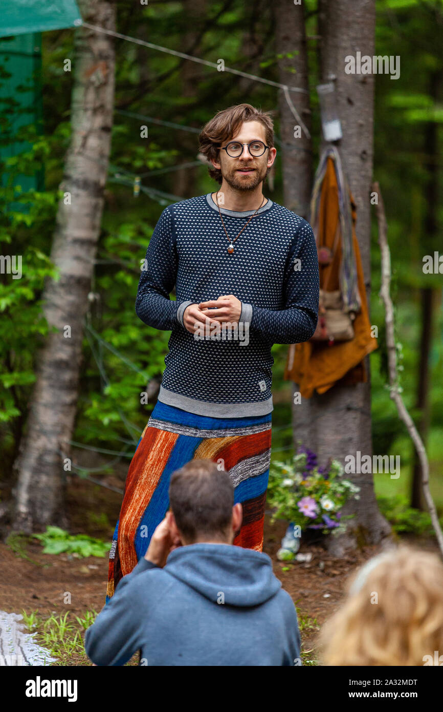A confident shaman man wearing glasses and colorful clothes is seen ...