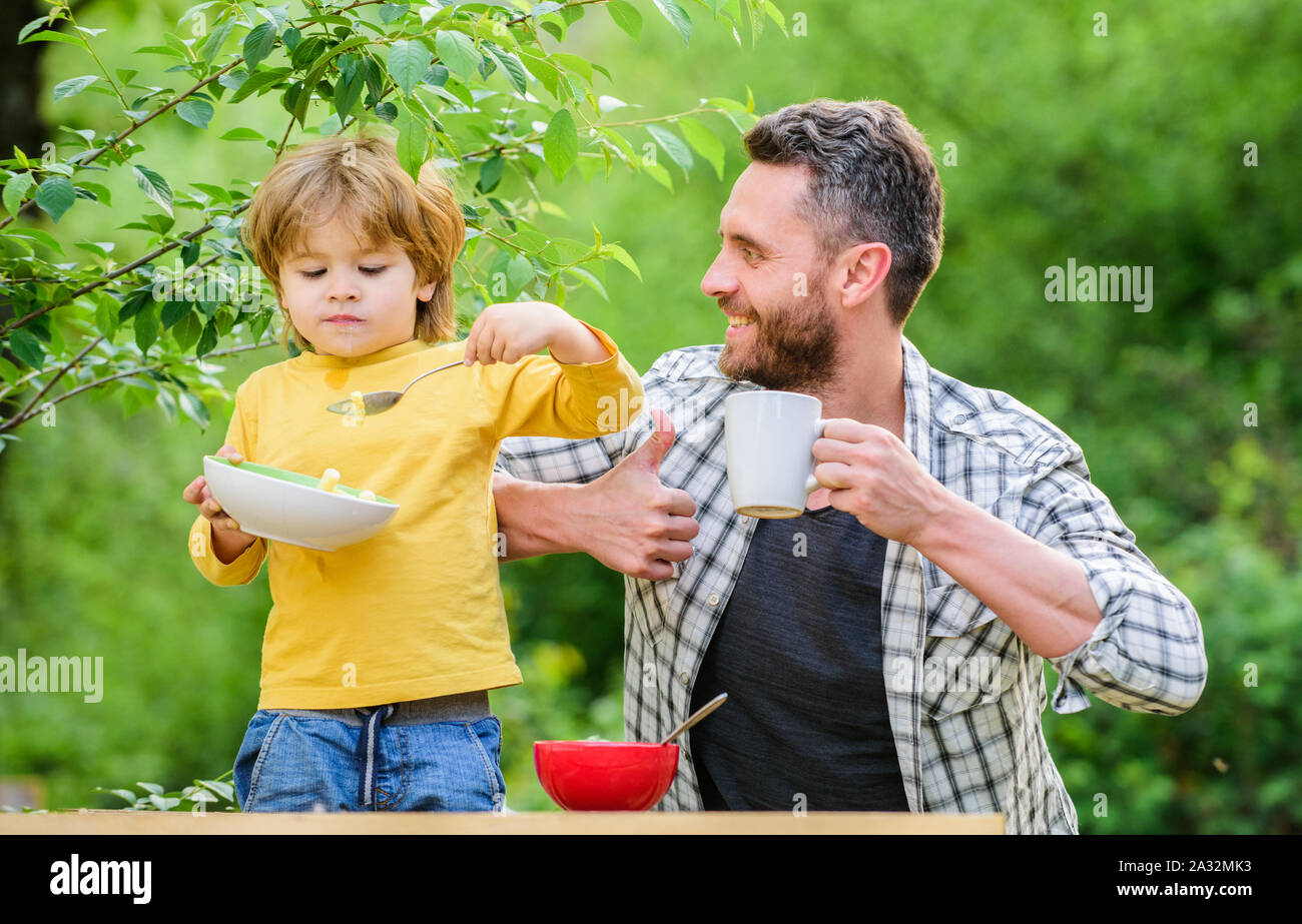 happy fathers day. Little boy with dad eat cereal. son and father ...