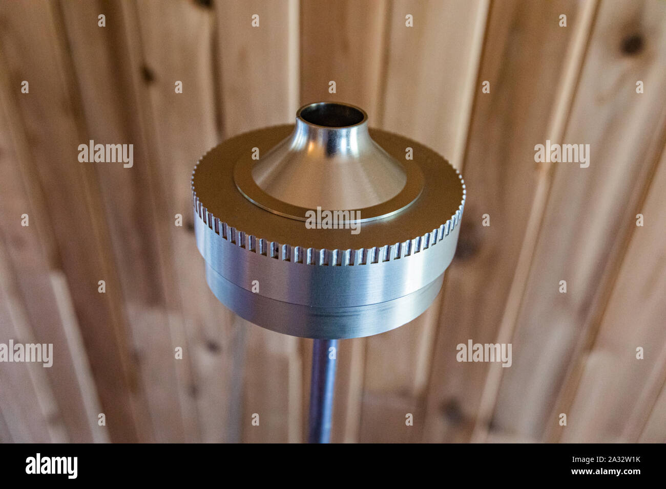 A close up view of a silver metal impactor device used inside a ...