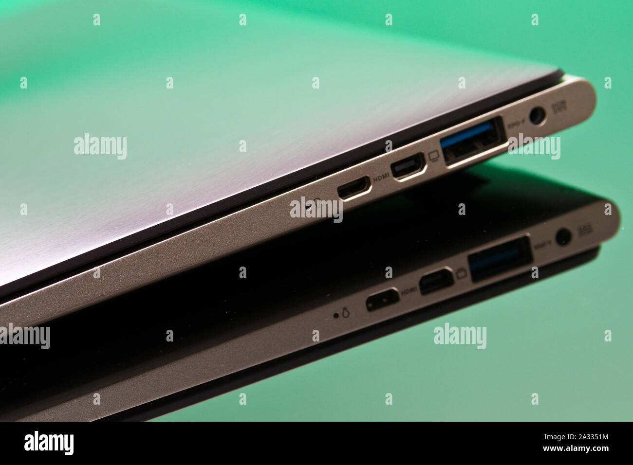 metal-finished laptop computer on reflective surface Stock Photo - Alamy