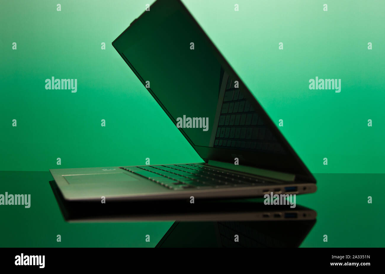 metal-finished laptop computer on reflective surface Stock Photo - Alamy