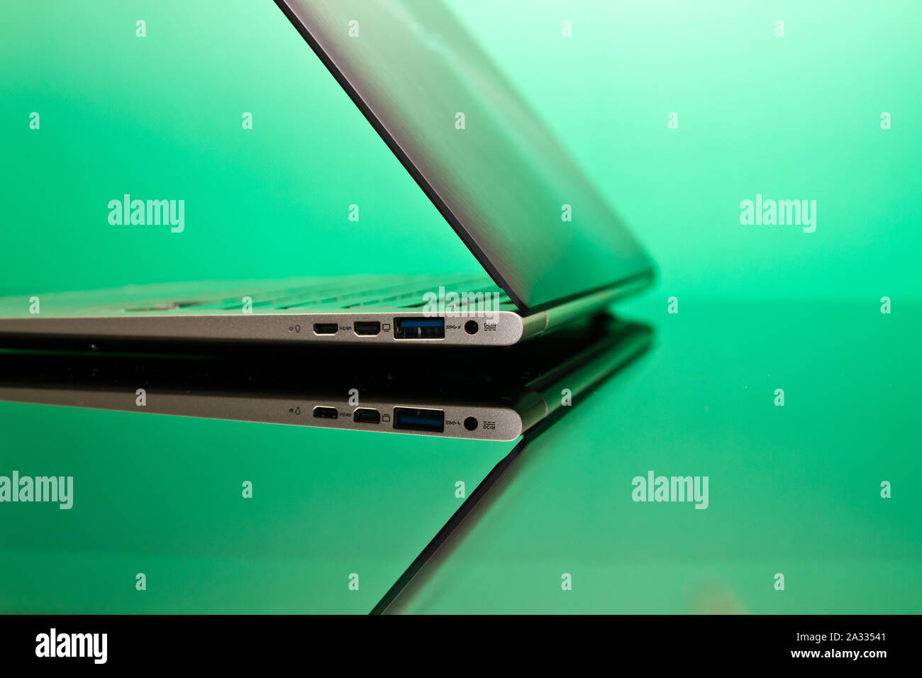metal-finished laptop computer on reflective surface Stock Photo - Alamy
