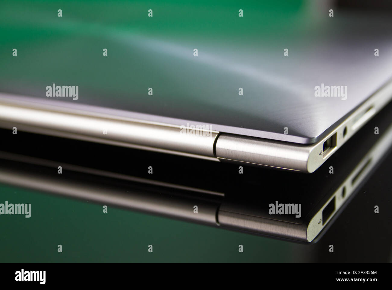 metal-finished laptop computer on reflective surface Stock Photo - Alamy