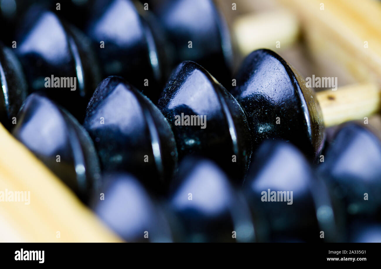 abacus with black beads on black reflective surface Stock Photo - Alamy