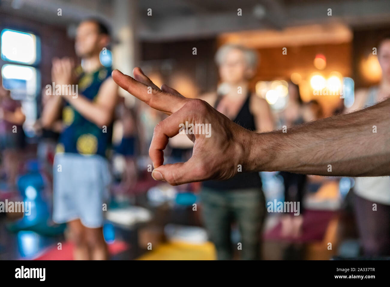 A motivational gym instructor is seen giving the ok hand gesture inside ...
