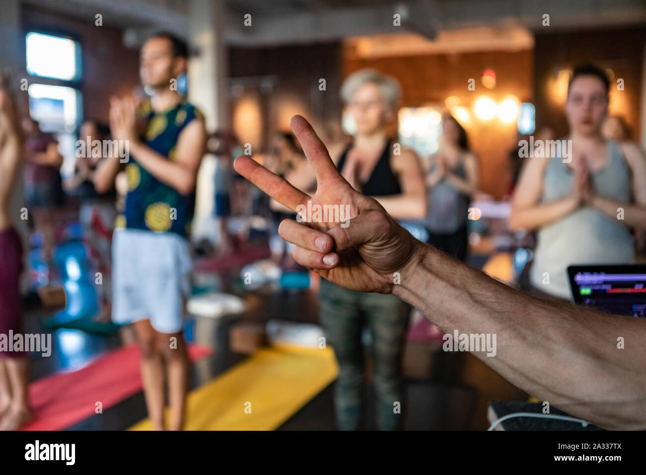 A close up view on the hand of a Caucasian man giving the v gesture ...