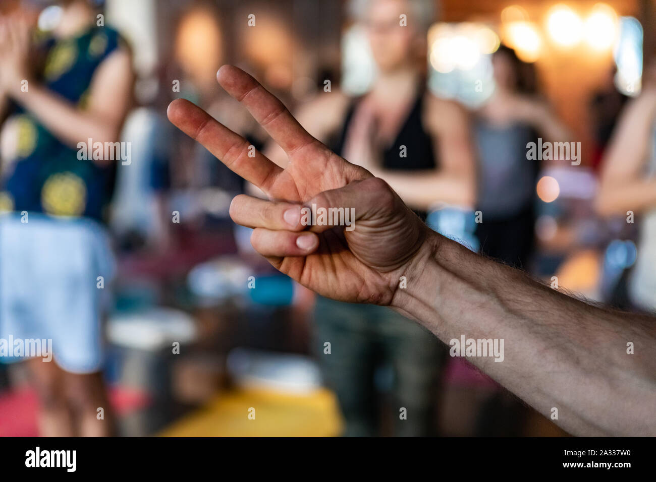 The hand of a motivational guy is viewed closeup, with fingers giving ...