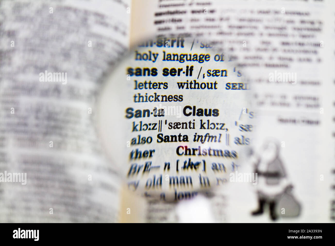 The Word Santa Claus Definition Through Magnifying Glass Stock Photo the-word-santa-claus-definition-through-magnifying-glass-stock-photo