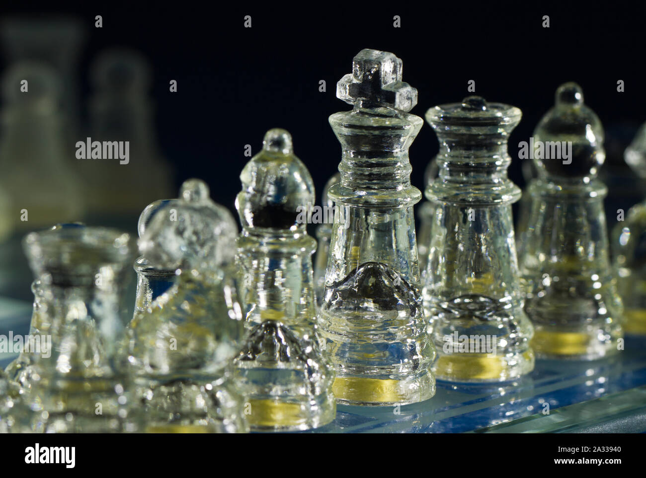 decorative glass chess set back-lighted with dark background Stock ...