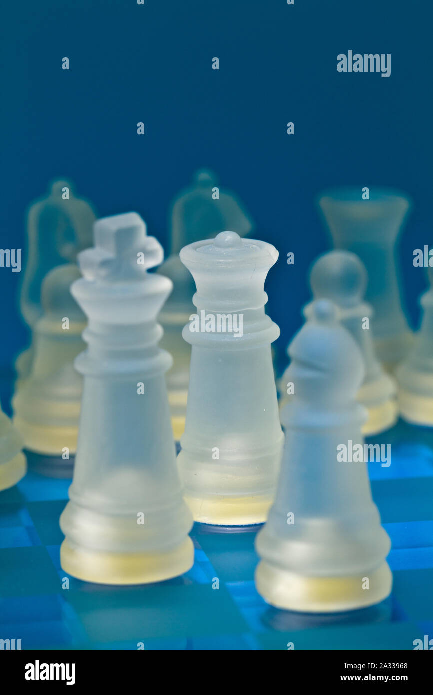 decorative glass chess set back-lighted with dark background Stock ...