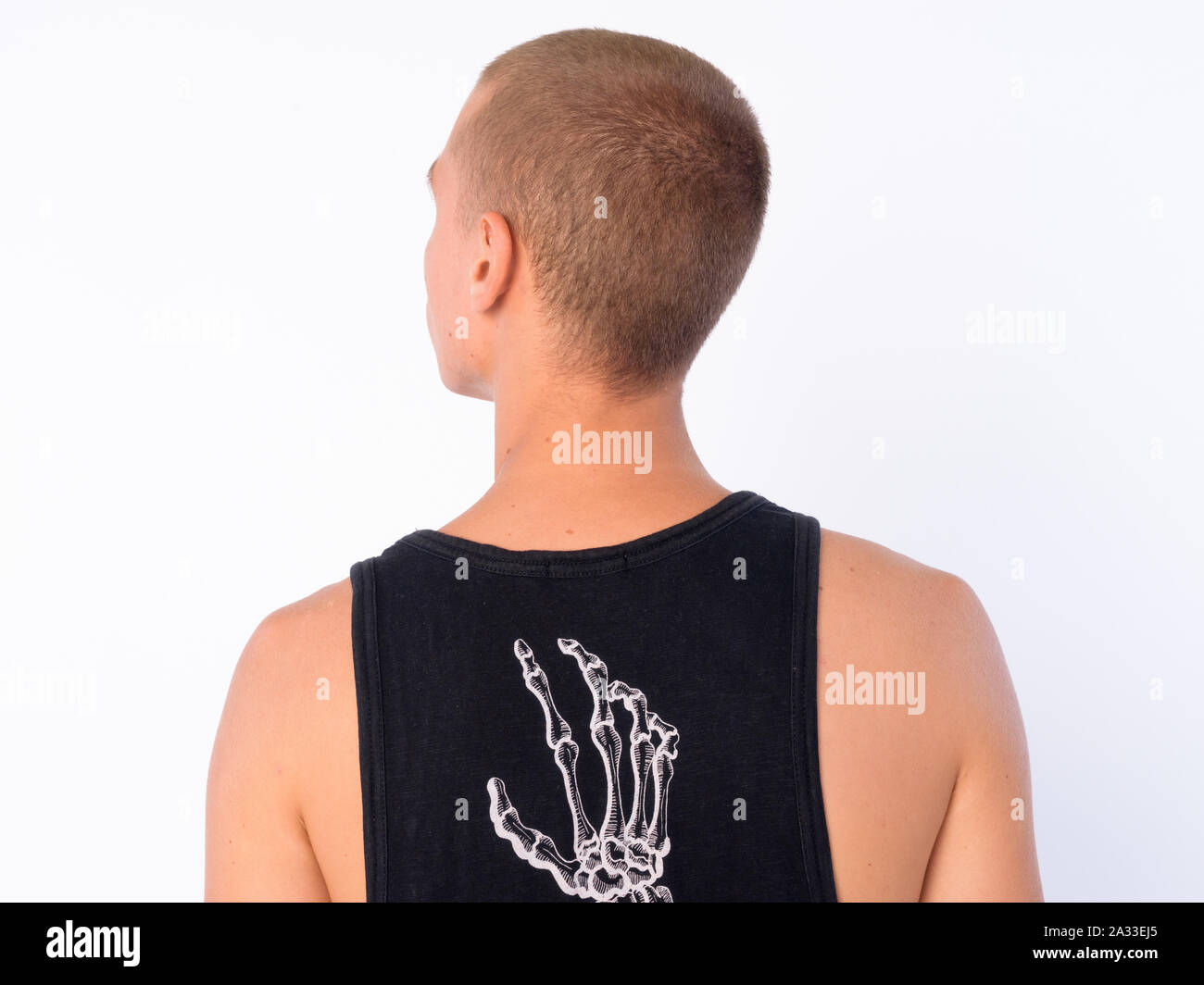 Closeup rear view of young bald rebellious man looking over shoulder ...