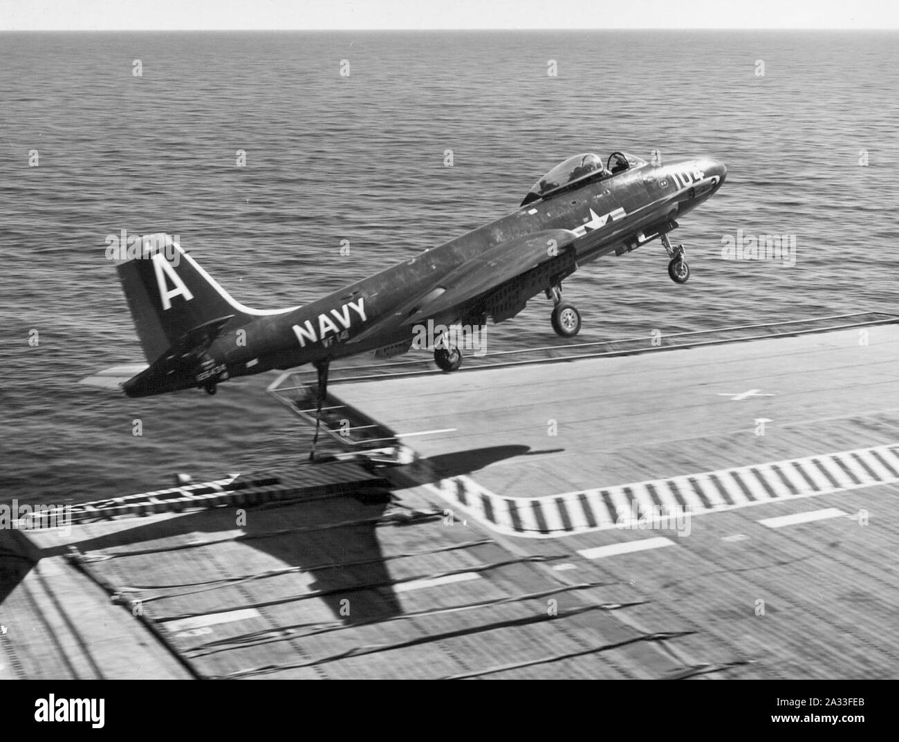 F2H-3 of VF-141 over flight deck of USS Randolph (CVA-15) 1954 Stock ...