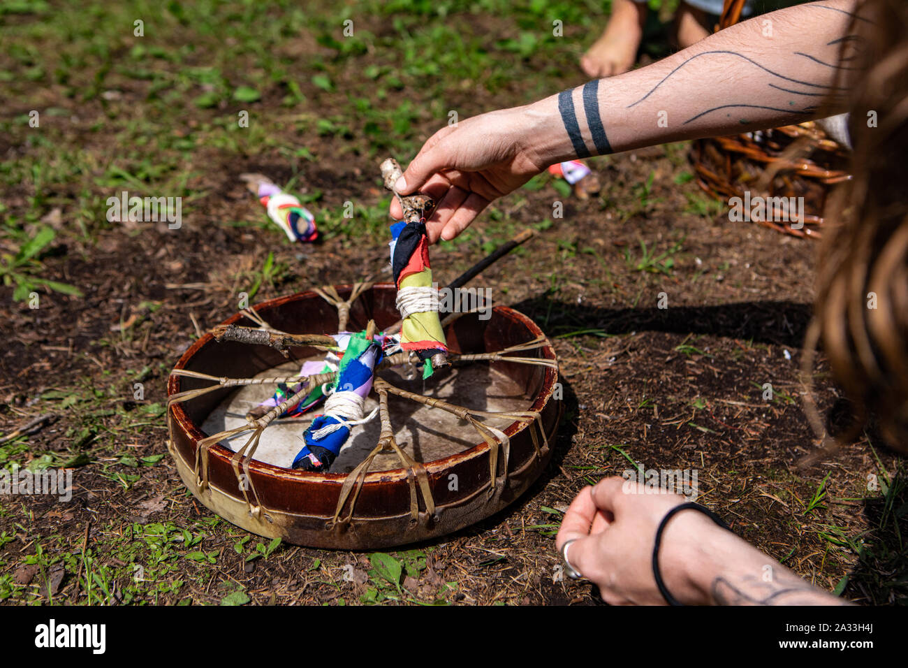 A closeup view on the hands of a shaman, placing sacred objects on a ...