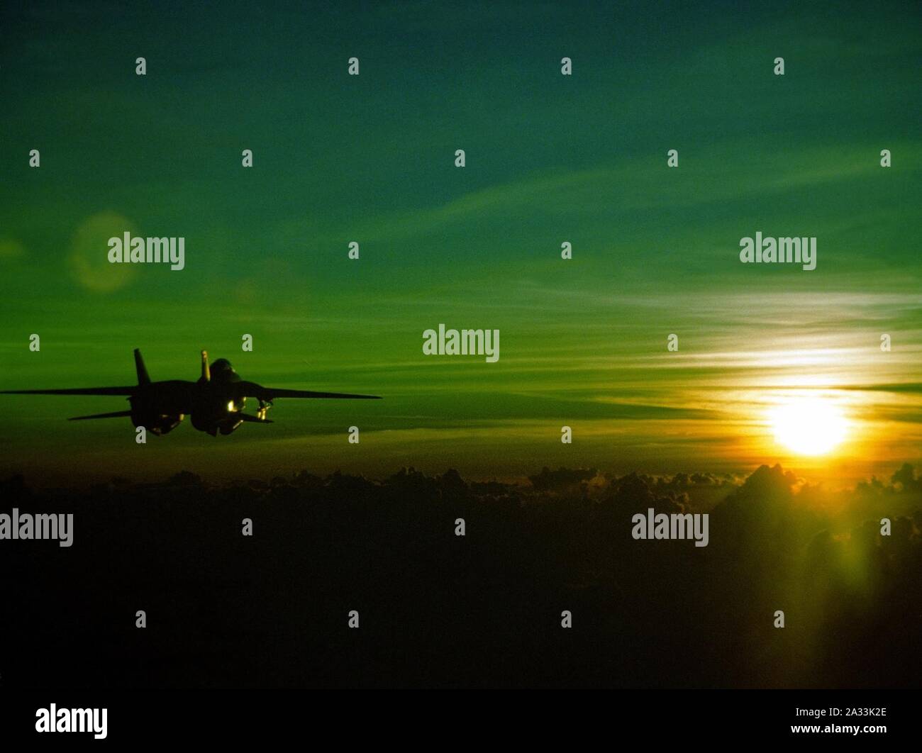 F-14A Tomcat flying against a green sunset Stock Photo - Alamy