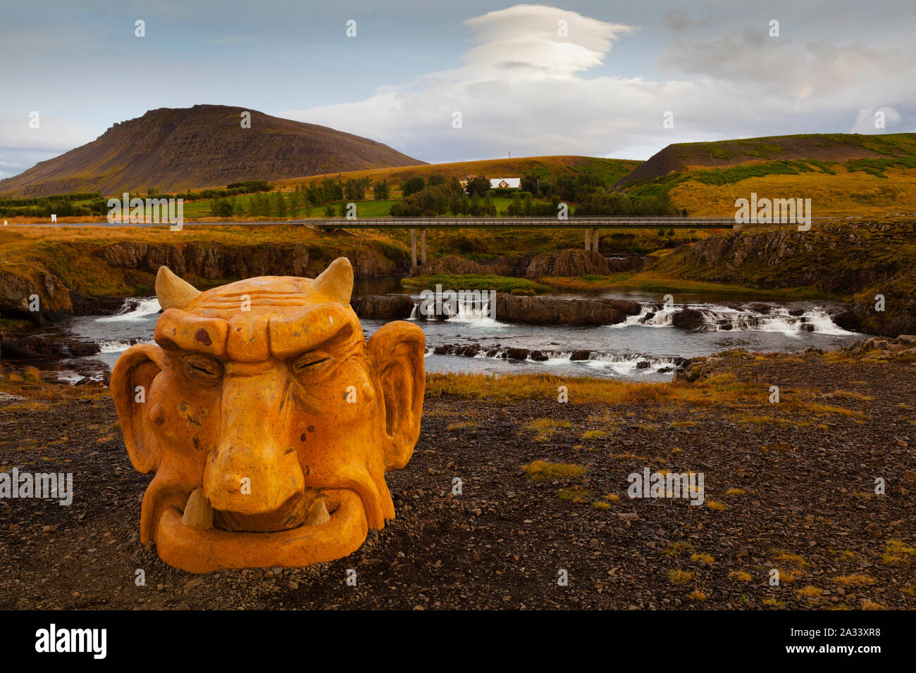 Troll head, waterfall and lenticular cloud at Fossatun, Iceland Stock ...