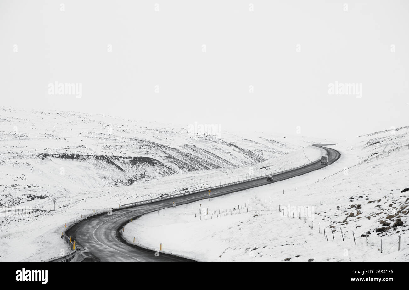 Uphill curve road with side way full of snow in winter Stock Photo - Alamy
