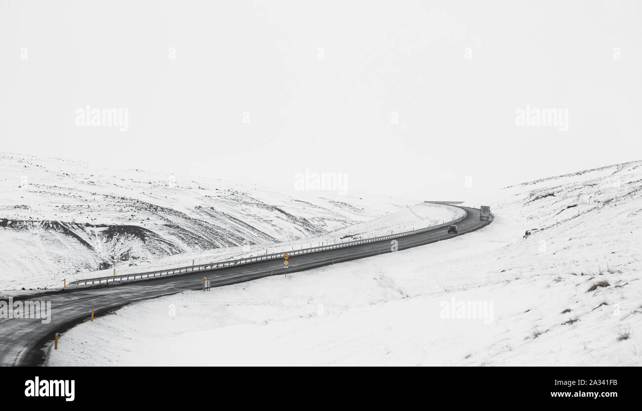 Uphill curve road with side way full of snow in winter Stock Photo - Alamy