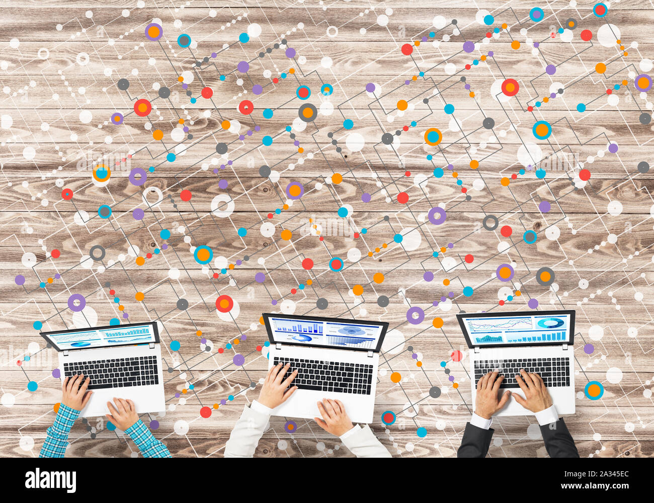 Group of three people with devices in hands working together as symbol ...